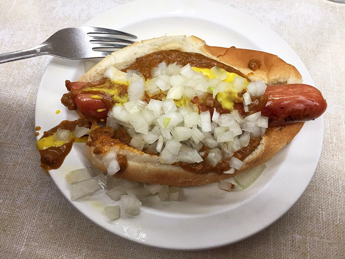 Behold the Detroit Coney in all its glory! That perfect trifecta of snap, chili, and sharp onions creates a symphony that's greater than the sum of its parts