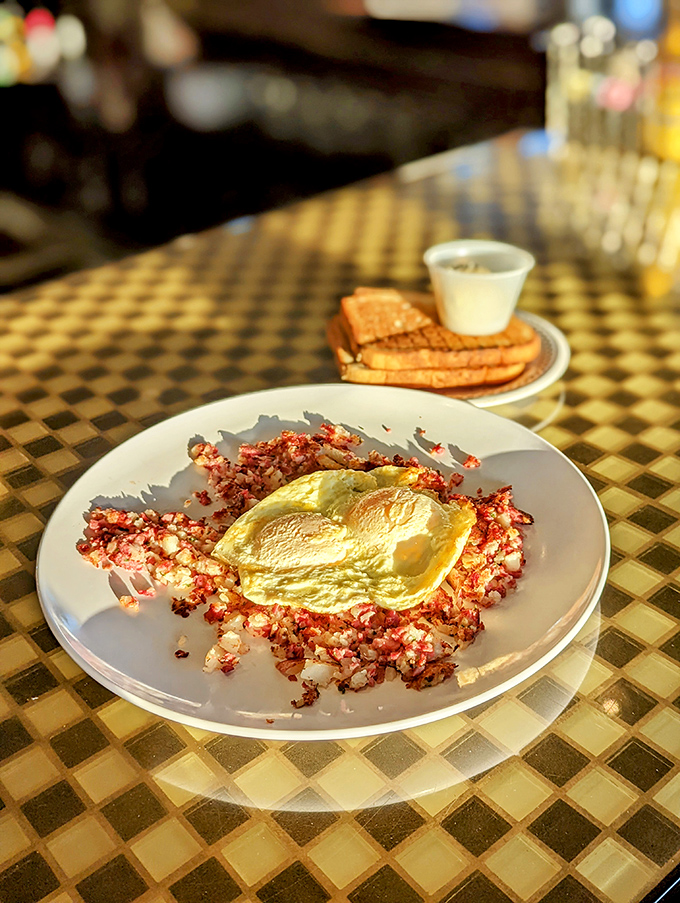 Corned beef hash that puts ordinary breakfasts to shame. That sunny-side up egg crowns a throne of crispy, savory perfection worth setting your alarm for.