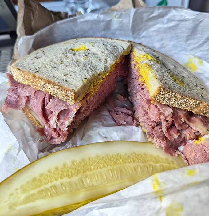 The star of the show in all its glory&mdash;layers of perfectly pink corned beef stacked between rye bread with a pickle standing guard. Architecture you can eat.