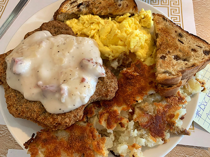 Behold the star attraction: country fried steak smothered in gravy that's clearly graduated from the University of Deliciousness with highest honors.