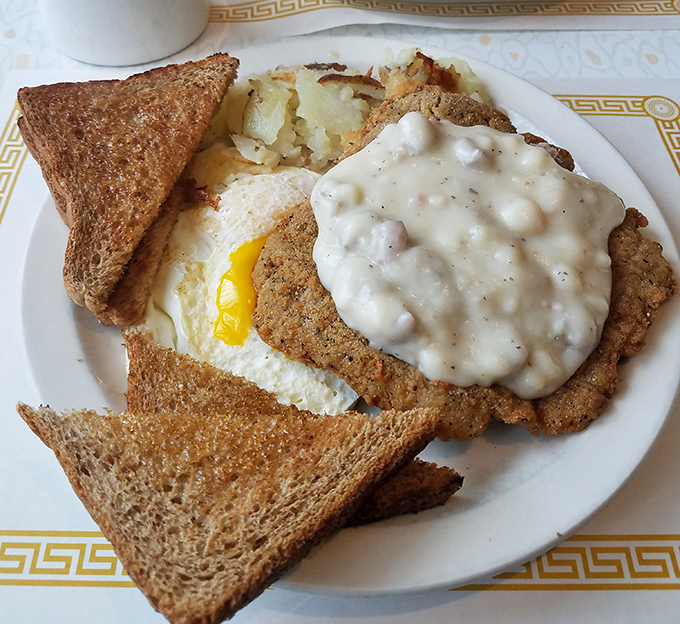 Behold the star attraction: country fried steak smothered in sausage gravy with perfectly cooked eggs. This plate has probably prevented more breakups than couples therapy. 