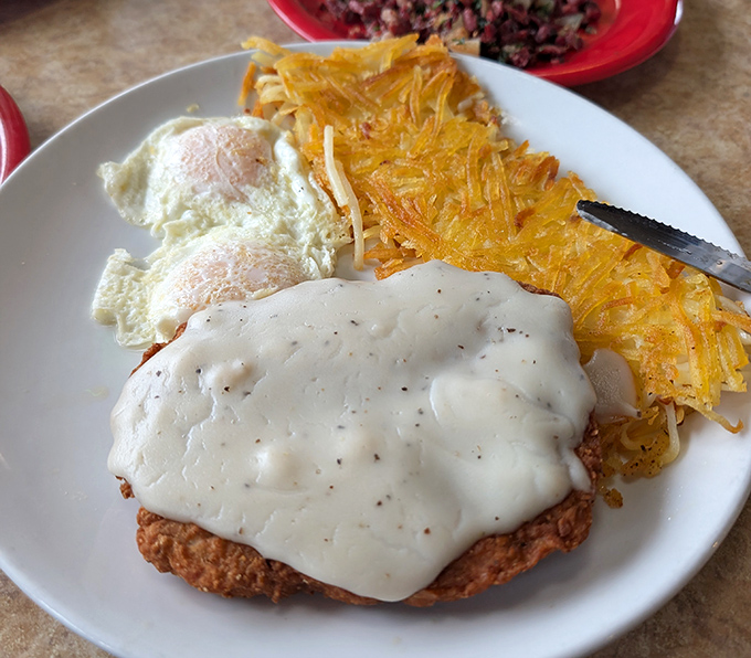 Country fried steak nirvana: crispy exterior, tender meat, and gravy that could make a vegetarian question their life choices. Comfort food perfection on a plate.