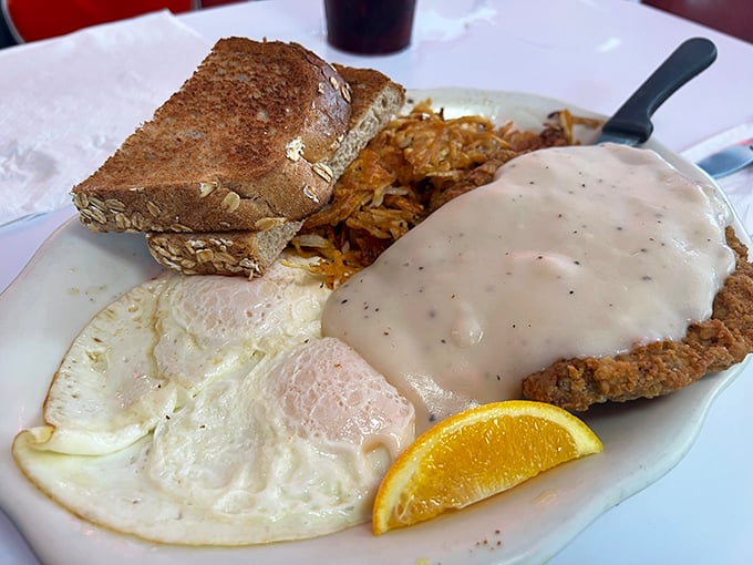 Behold the star attraction: country fried steak smothered in pepper gravy alongside sunny eggs. This plate doesn't just satisfy hunger&mdash;it creates food memories.