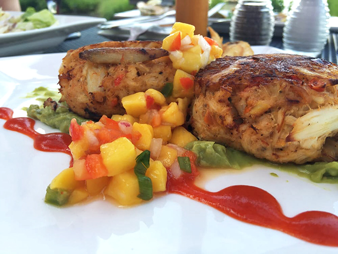 These aren't your average crab cakes—they're more like crab condominiums, where lump meat gets the penthouse treatment with mango salsa as the stylish neighbor.