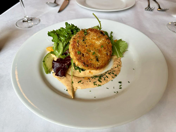 The star of the show! This golden-crusted crab cake isn't just food; it's edible evidence that simplicity and perfection often go hand in hand.