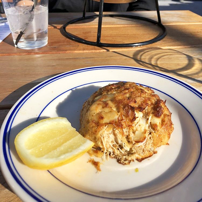 The legendary crab cake in all its golden-crusted glory. Notice how it's barely holding together&mdash;that's pure crab meat, folks, not filler.