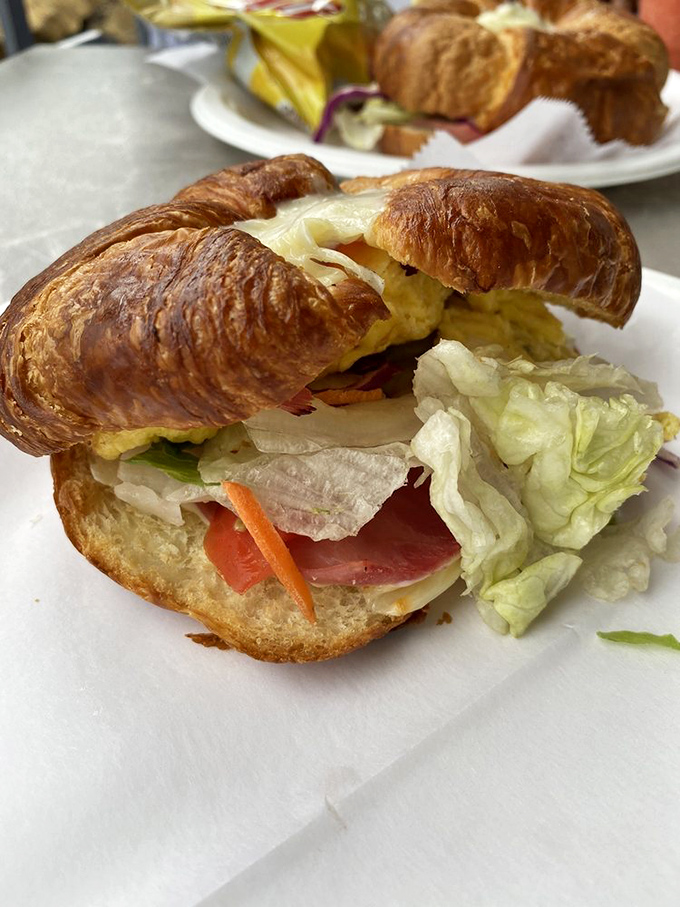 This croissant sandwich isn't just breakfast—it's architecture. Flaky layers cradle fresh veggies and savory ham in perfect harmony.