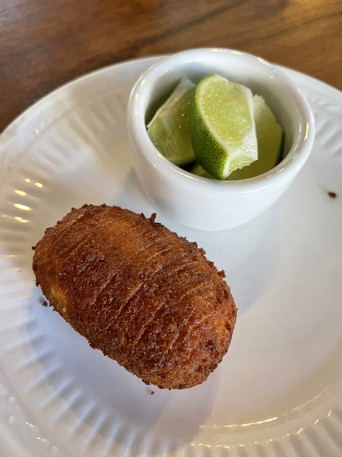 The golden-brown croqueta, perfectly cylindrical and served with lime, isn't just fried food&mdash;it's a masterclass in textural contrast that'll ruin lesser croquetas for you forever.