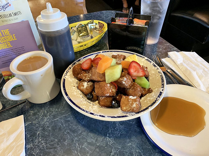 The legendary Cuban French toast arrives like breakfast royalty, crowned with fresh fruit and dusted with powdered sugar. Worth setting your alarm for, even on weekends.