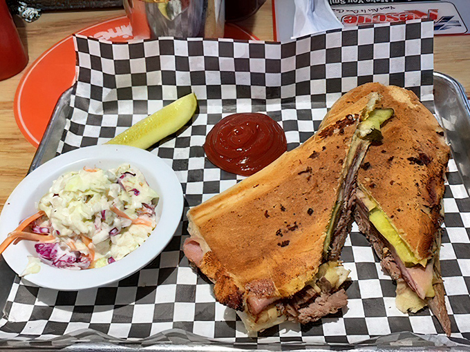 Cuban Sandwich: Architecture in sandwich form&mdash;layers of slow-roasted pork, ham, and pickle creating perfect structural integrity while that side of coleslaw provides a cooling counterpoint.
