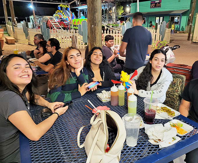 Nothing builds friendships like sharing street food at colorful tables&mdash;these smiling faces know the universal truth that the best conversations happen over good eats.