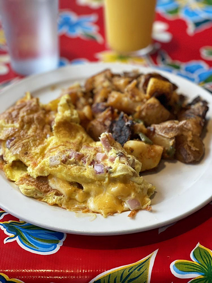 That's not just an omelet&mdash;it's a cheese-oozing masterpiece paired with crispy potatoes that would make any morning person weak at the knees.