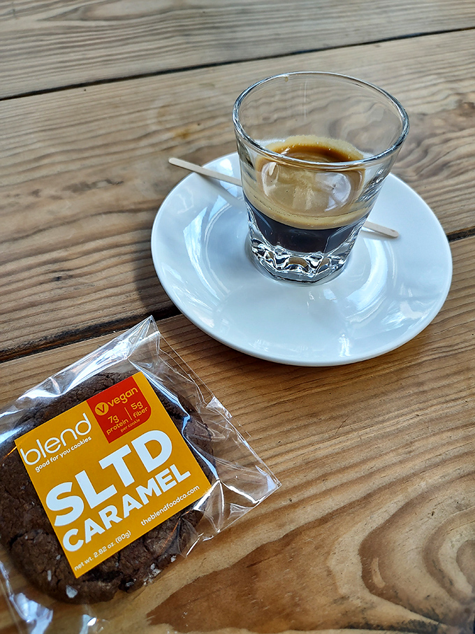 This espresso isn't just a drink, it's a tiny cup of liquid motivation sitting pretty on weathered wood.