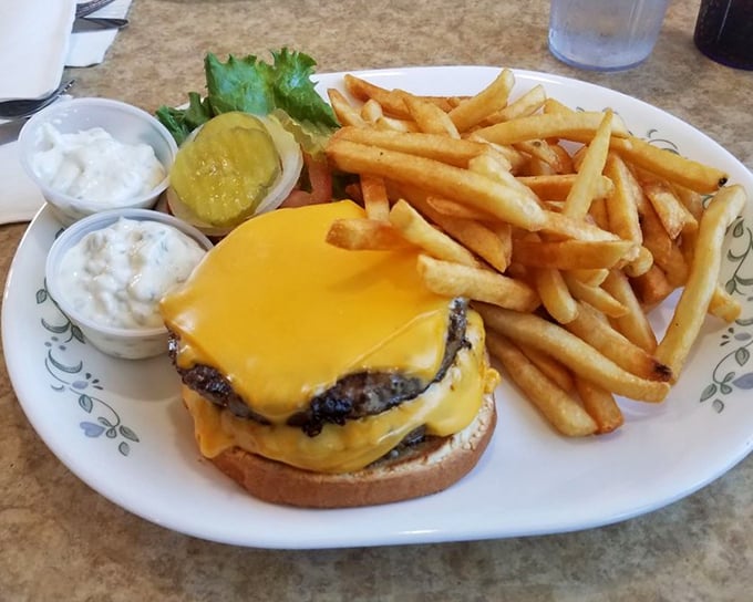 Behold the cheeseburger in its platonic ideal form: melty American cheese cascading over a hand-formed patty with crispy fries standing guard.