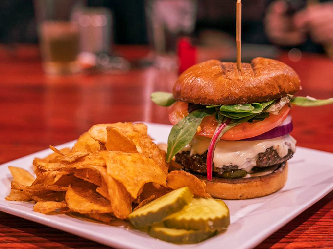 This isn't just a burger; it's an architectural marvel of beef, cheese, and fresh veggies. The house-made chips and pickle spear aren't sidekicks&mdash;they're essential supporting characters.