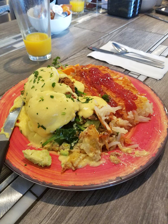Behold the star of the show! This Eggs Benedict features perfectly poached eggs draped in hollandaise that cascades like a golden waterfall. Breakfast royalty.