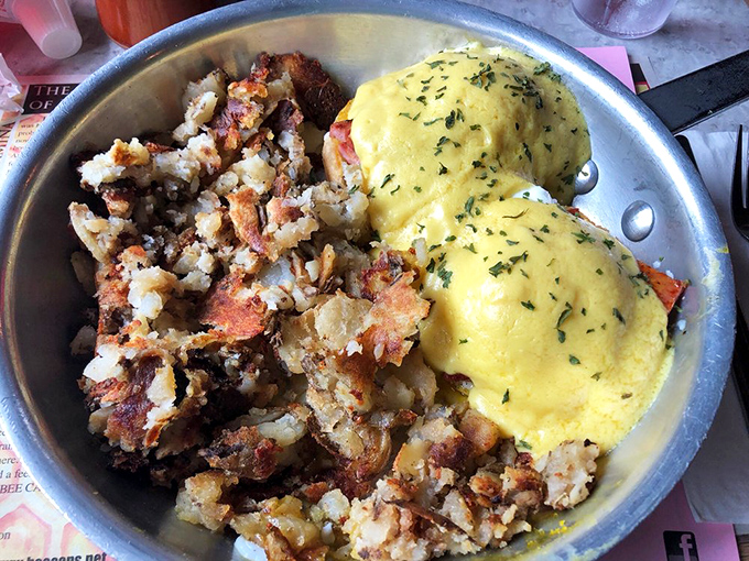 Eggs Benedict that would make a French chef weep with joy, paired with home fries that achieve the perfect crisp-to-fluffy ratio.