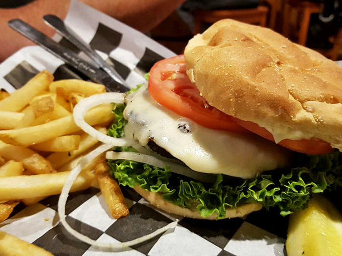 This isn't just a burger, it's architecture with cheese. Fresh lettuce, tomato, and onion provide structural integrity to this towering creation.