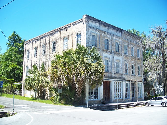Three stories of history housed in weathered brick and framed by palmettos. This cornerstone building has witnessed generations of Micanopy life unfold.
