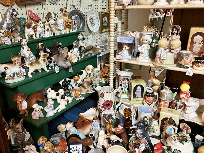 Dog figurines galore! Enough ceramic pups to make Westminster jealous, each one frozen mid-bark from another era.