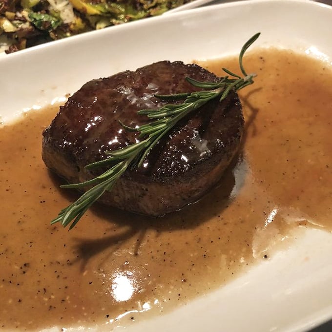 This filet mignon isn't just cooked&mdash;it's been transformed into meat poetry, complete with a rosemary garnish that's not just for show.