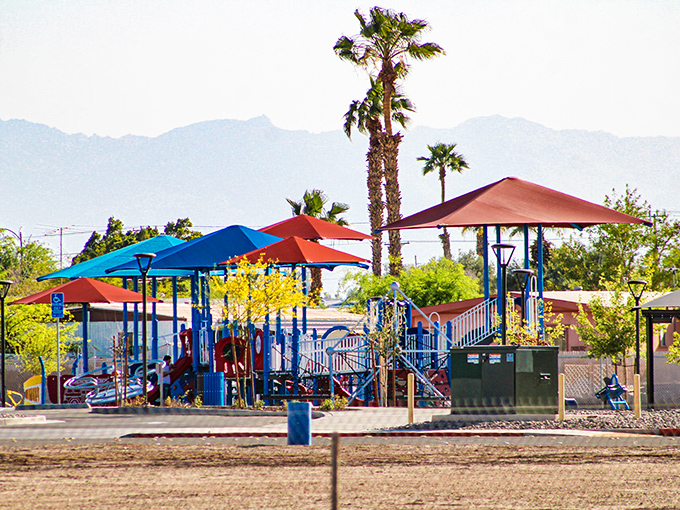 Colorful playground equipment pops against the mountain backdrop, a welcome oasis for families seeking shade and fun in equal measure.