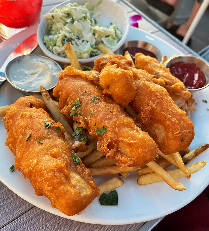 Golden-battered fish perched atop crispy fries &ndash; this isn't just fish and chips, it's edible sunshine that crunches, the dish that launched a thousand local loyalties.