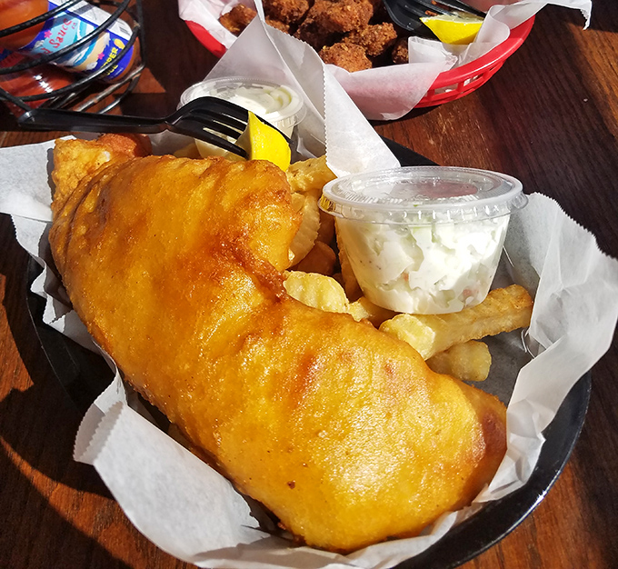 Golden-battered fish that shatters with each bite, revealing pearly white flesh within. The kind of fish and chips that makes British expats weep with joy.