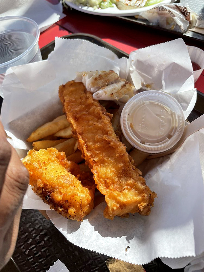 Golden-battered fish that shatters with each bite, revealing pearly white flesh beneath. This is what seafood dreams are made of.