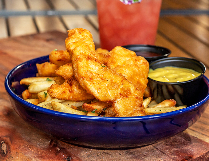Golden-battered haddock perched atop a mountain of fries &ndash; this isn't just fish and chips, it's edible sunshine that crunches in all the right places.