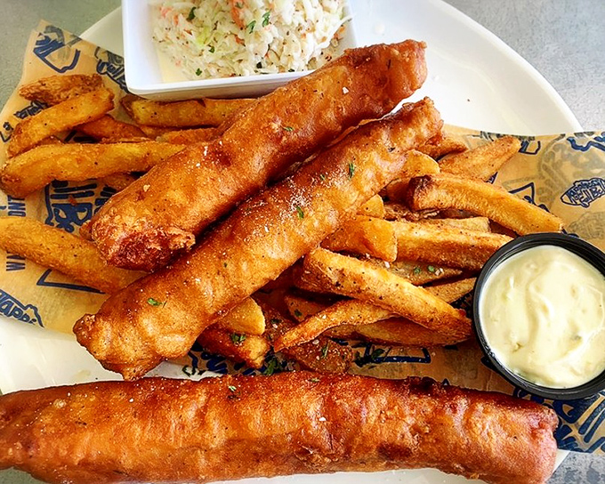 Golden-battered fish so crispy you can practically hear the crunch through the photo, paired with fries that demand to be dunked.