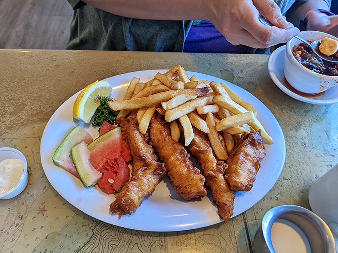 Golden perfection arrives looking like it graduated summa cum laude from fish and chips university.