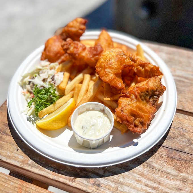 Golden-battered fish that shatters with each bite, alongside perfectly crisp fries. This isn't just fish and chips&mdash;it's edible sunshine on a plate.