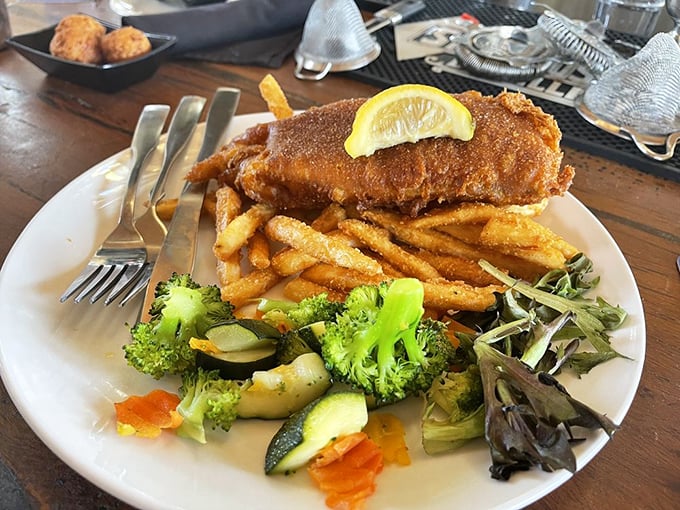 Golden-battered fish that shatters like glass, paired with fries that could make a British pub jealous. The side salad? Just there to ease your conscience.