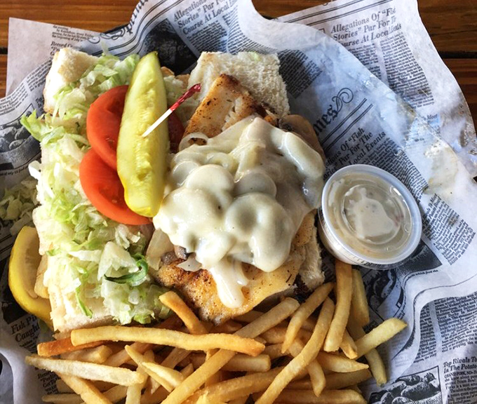 This golden-crusted hogfish sandwich arrives looking like it just won the lottery and wants to share the wealth.