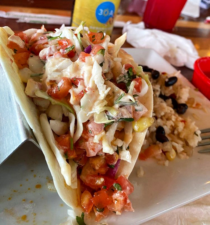 This isn't just a fish taco&mdash;it's edible architecture. Fresh Gulf catch, vibrant pico, and that sauce that'll haunt your dreams for weeks.