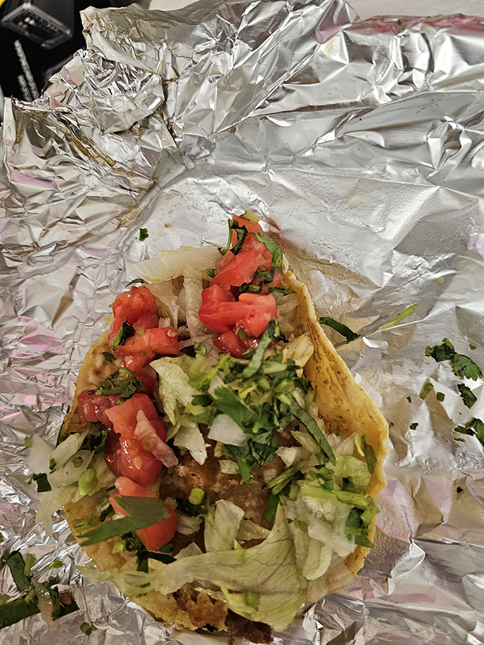 This isn't just a taco—it's an architectural marvel of perfectly balanced flavors, where each ingredient knows its role yet still manages to shine.