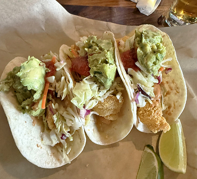 These fish tacos don't just speak&mdash;they sing! Crispy beer-battered perfection topped with fresh slaw and avocado, with lime standing by for duty.