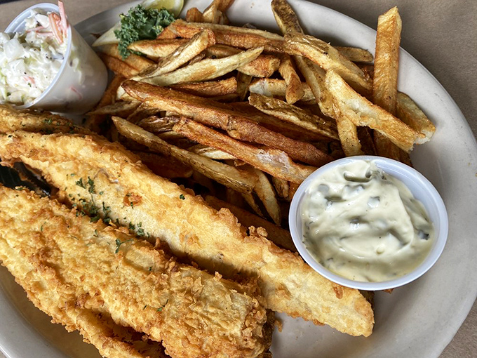 Golden-battered fish that shatters with each bite, alongside hand-cut fries that achieve potato perfection. This is fish and chips nirvana.