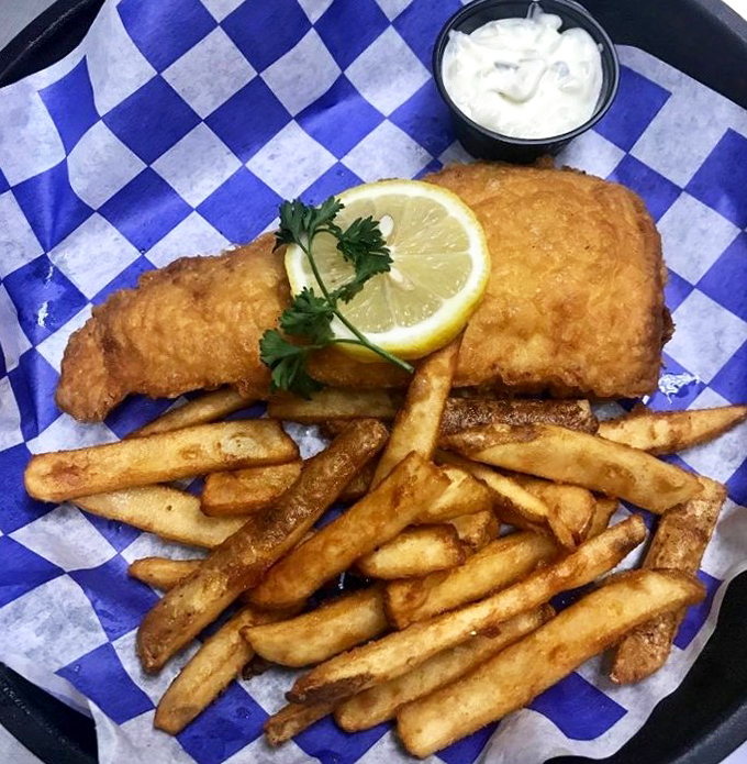 Golden, crispy perfection on a blue-checkered throne. This fish fry doesn't need a royal announcement—it speaks for itself.