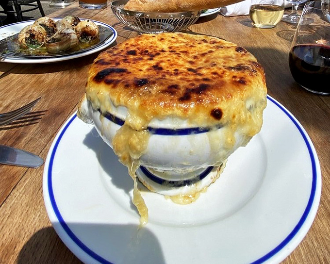 The legendary French onion soup arrives like a volcanic cheese eruption. That golden dome of bubbling Gruy&egrave;re is what food dreams&mdash;and return trips&mdash;are made of.
