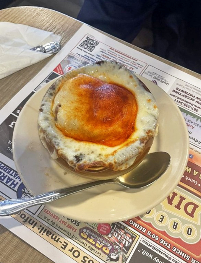 French onion soup that's having an identity crisis as a cheese delivery system. That golden dome of broiled perfection is worth every chin burn.