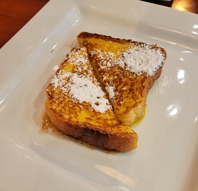 French toast that's dressed better than most people at breakfast&mdash;powdered sugar as delicate as first snow on golden, crispy bread.