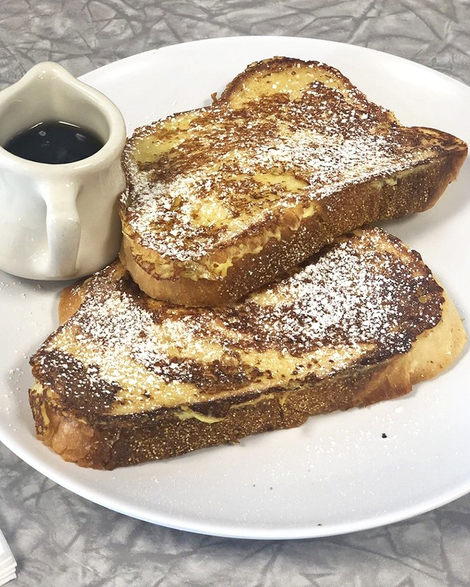 French toast nirvana achieved! Golden-brown perfection with a dusting of powdered sugar that transforms ordinary bread into breakfast royalty.
