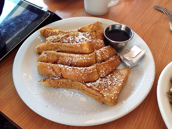 Golden-brown perfection dusted with powdered sugar like a light snowfall on breakfast mountain. This French toast doesn't need Instagram filters to look this good.