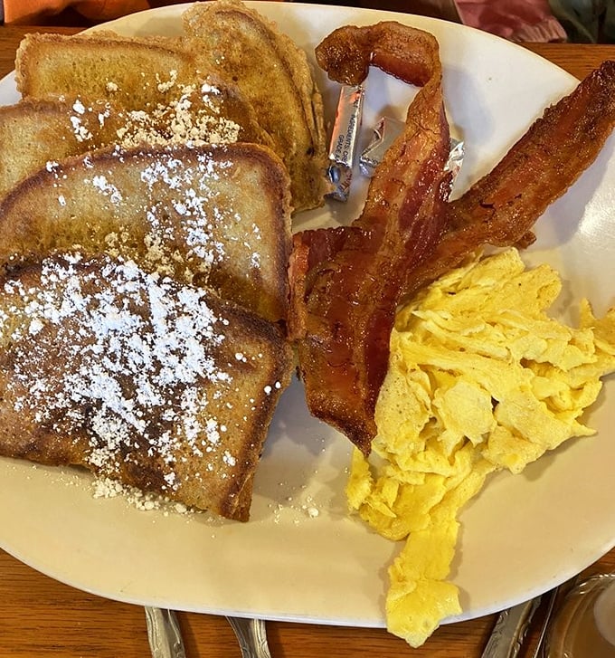 French toast that's achieved the perfect golden-brown status, dusted with powdered sugar and flanked by eggs and bacon&mdash;breakfast's holy trinity.