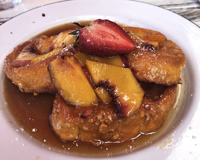 French toast that doesn't just break the fast&mdash;it shatters expectations. Golden-brown perfection swimming in syrup with fresh fruit that makes mornings worth facing.
