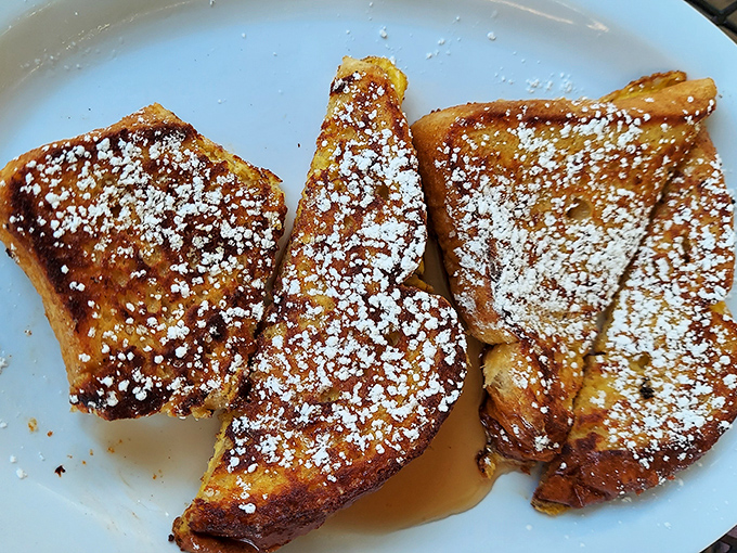 Golden, crispy exterior. Custardy, pillowy interior. This French toast doesn't just set the bar&mdash;it is the bar. That dusting of powdered sugar? Chef's kiss.