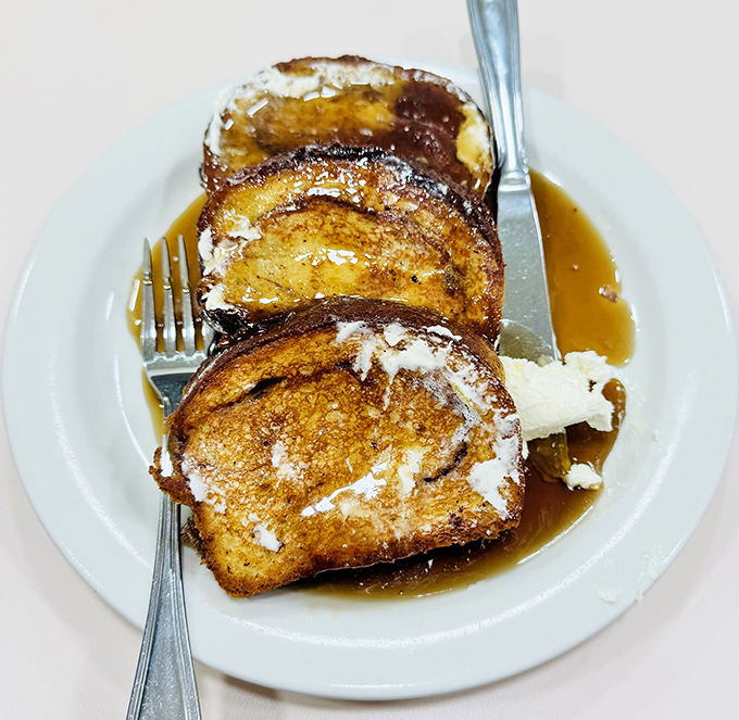 The legendary French toast in all its glory&mdash;golden-brown perfection with a dusting of powdered sugar that makes breakfast feel like a celebration.