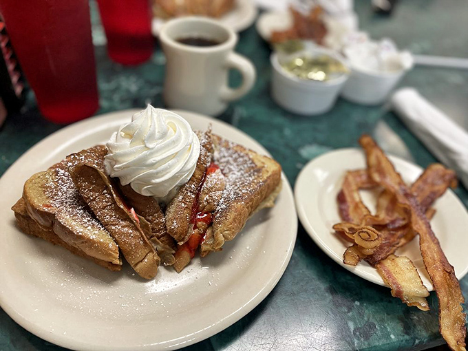 Stuffed French toast that makes you wonder why regular toast even exists. That whipped cream mountain isn't just decoration—it's a necessity.